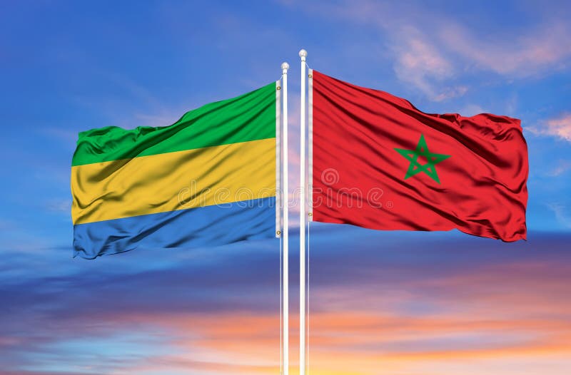 Morocco and Gabon Two Flags on Flagpoles and Blue Cloudy Sky Stock ...