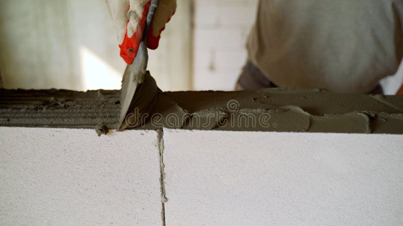 The Mortar is Applied To the Wall Masonry Block. Construction Worker ...