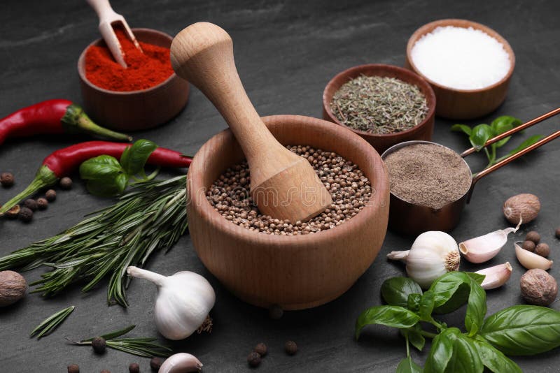 Mortar with Pestle and Different Spices on Black Table Stock Image ...