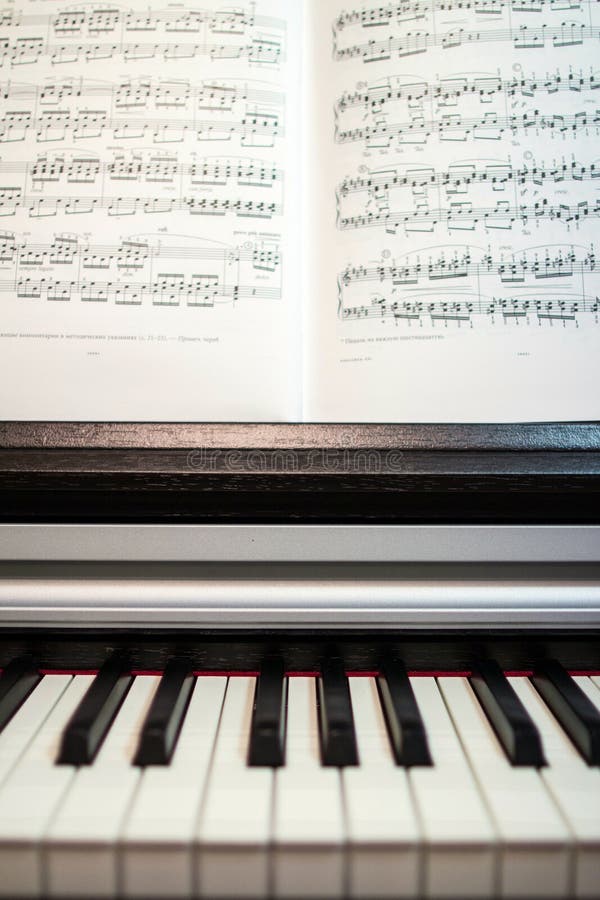 An Open Book of Sheet Music on the Piano. a Composition of the Sheet ...