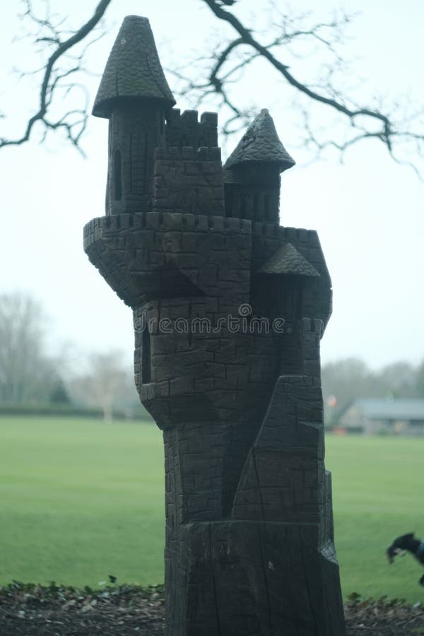 A Tree Trunk Has a Castle Made Out of Logs and Moss Stock Photo - Image ...