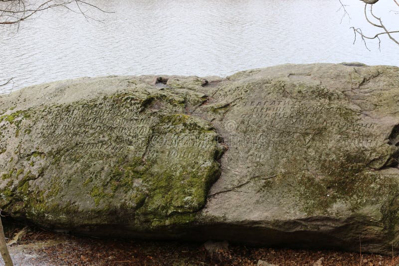 A Mossy Huge Boulder Lies in the Water Off the Coast. Embossed Letters ...
