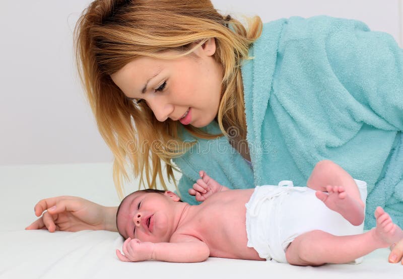 Happy Young Mother Snuggling Newborn Baby Daughter in Bed Stock Photo ...