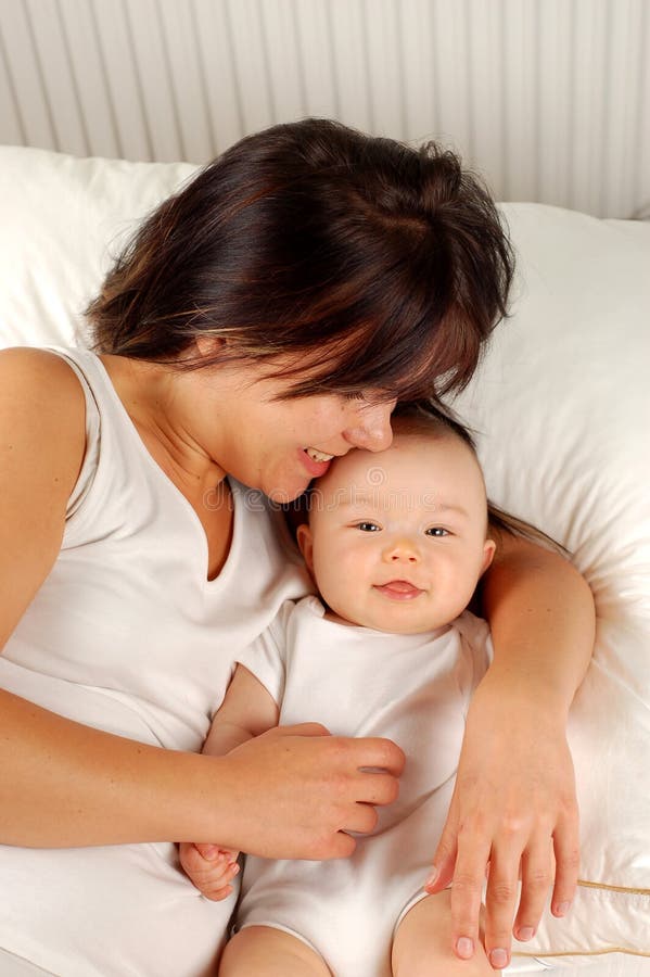 Young Mother and Newborn Baby in White Bedroom Stock Image - Image of ...