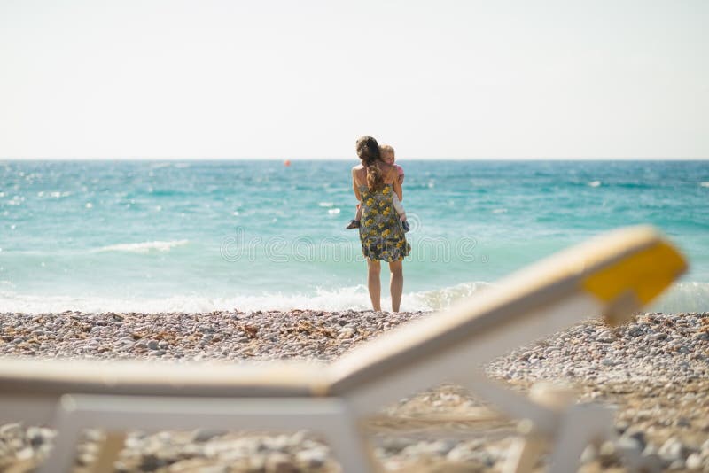 Mother with Baby on Beach. Rear View Stock Photo - Image of outdoors ...