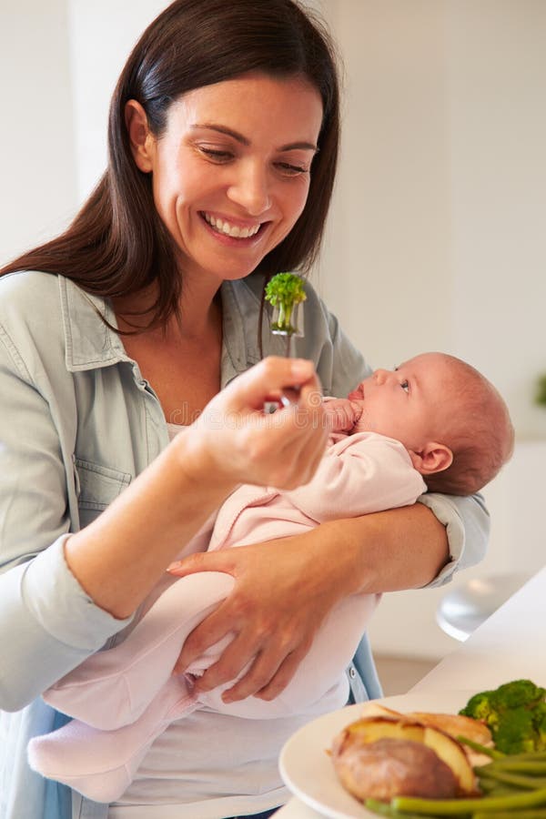 Mother with Baby Eating Healthy Meal in Kitchen Stock Image - Image of ...