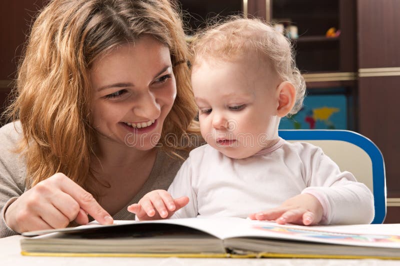 Mother Reading a Book a Little Baby on the Sofa Stock Image - Image of ...