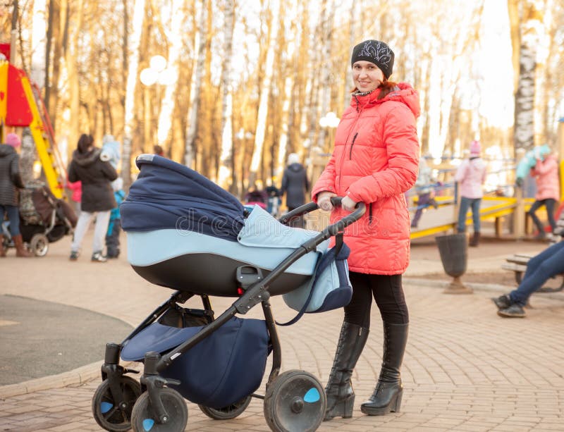 Mother with Baby in Stroller Stock Photo - Image of happy, walking ...