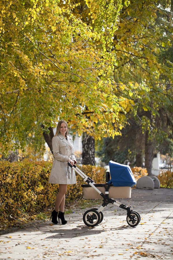 Mother with Baby Stroller for a Newborn Stock Image - Image of beauty ...