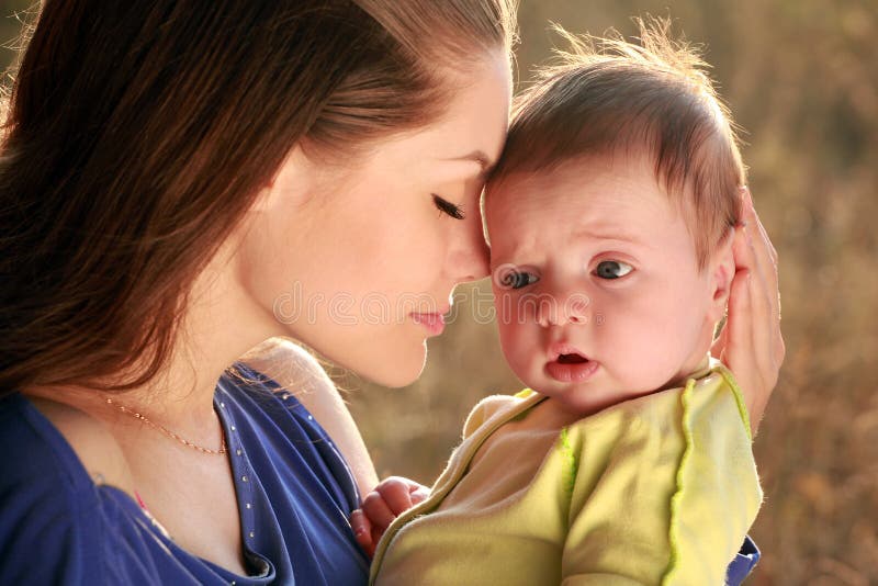 Mother and baby on sunset stock photo. Image of hairstyle - 10924832