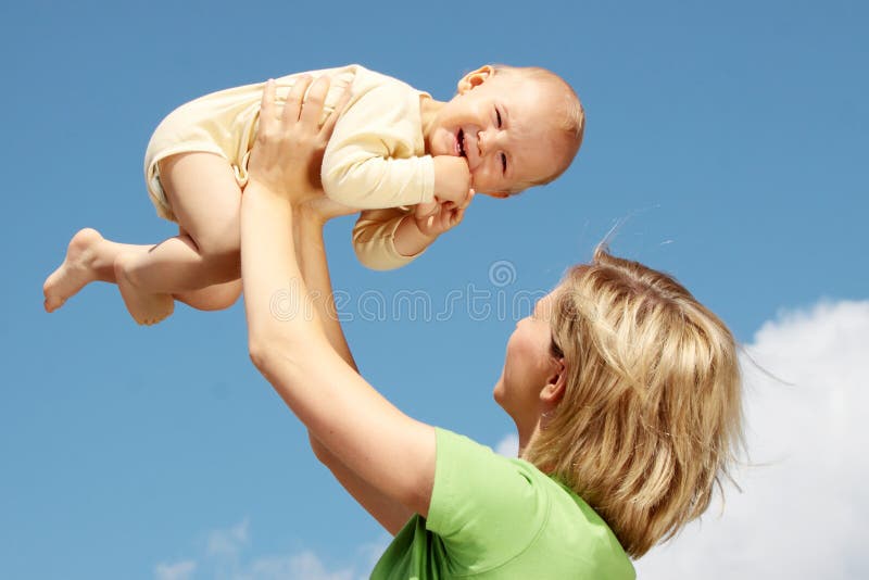 Mother with Baby Under Blue Sky Stock Photo - Image of beautiful ...