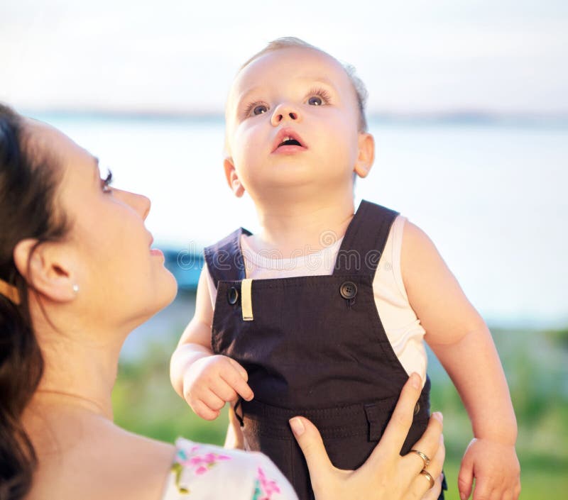 Mother Carrying Her Thoughtful Baby Stock Image - Image of greenery ...