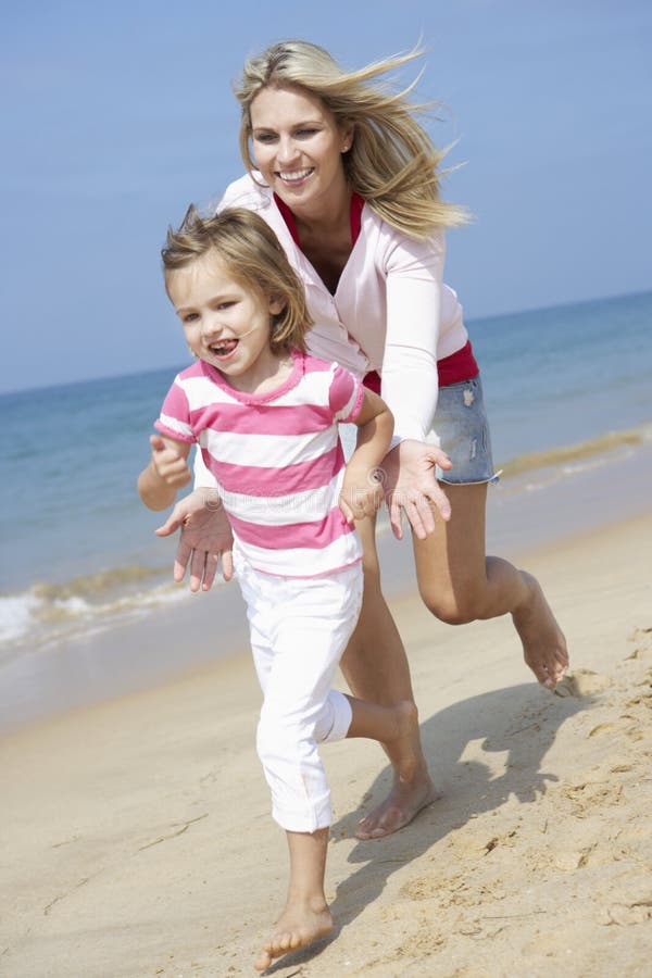 Mother Chasing Daughter through Sand Dunes Stock Photo - Image of ...