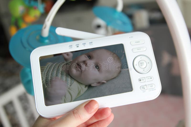 Mother is Checking the Baby Monitor for Security of the Baby Stock ...