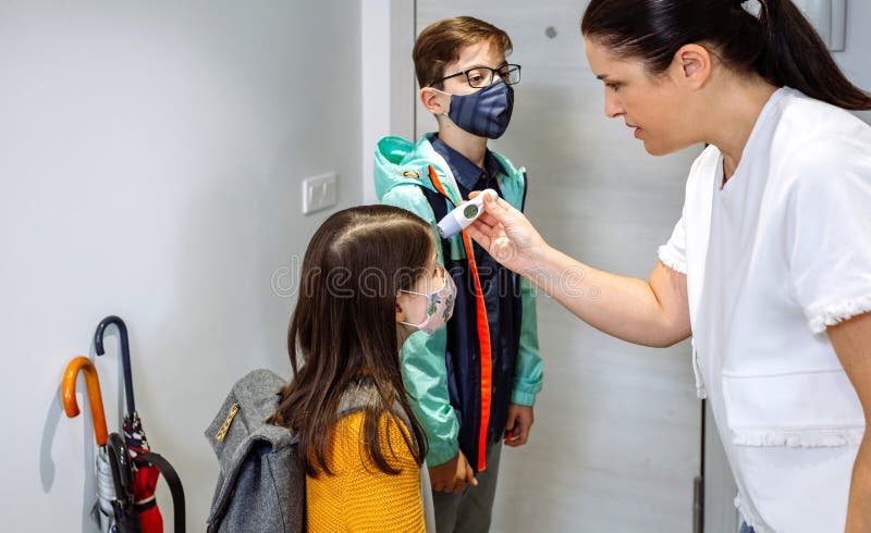 Mother Checking Her Daughter`s Temperature before Going To School Stock ...