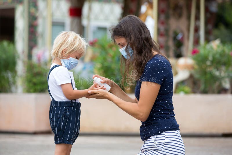 Mother and Child, Boy and Mom, Wearing Masks and Using Disinfection ...