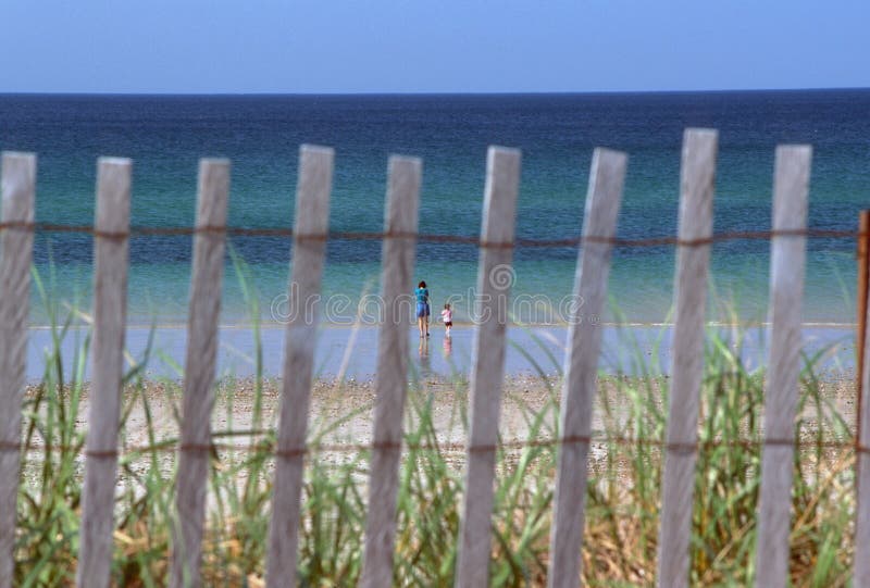Mother and Child on Cape Cod Beach between Fence Posts. Stock Image ...