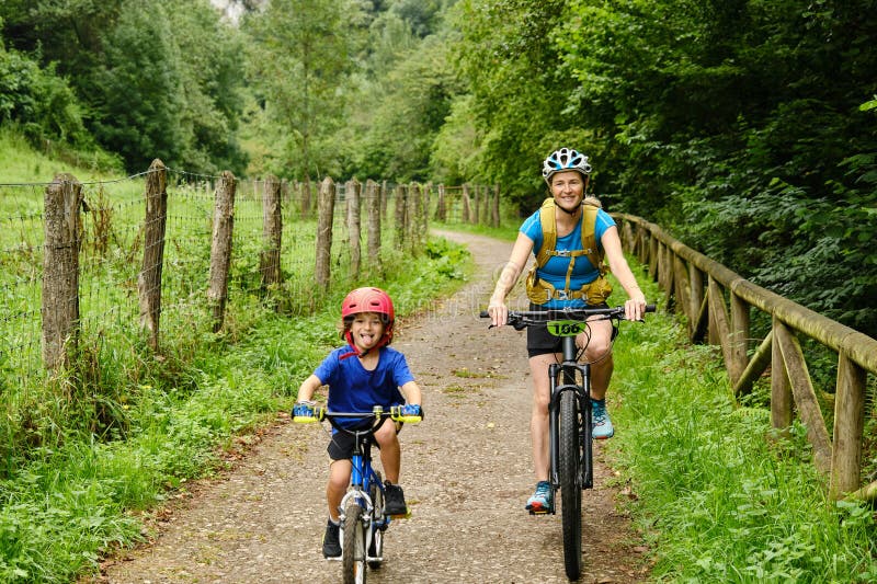 Mother and Child Cycling in Nature Stock Photo - Image of affectionate ...