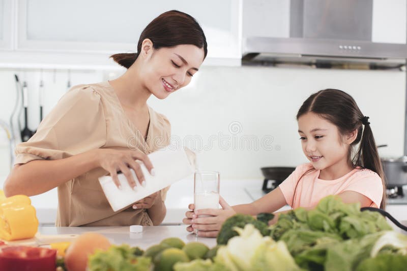 Mother and Child Drinking Milk at the Kitchen Stock Image - Image of ...
