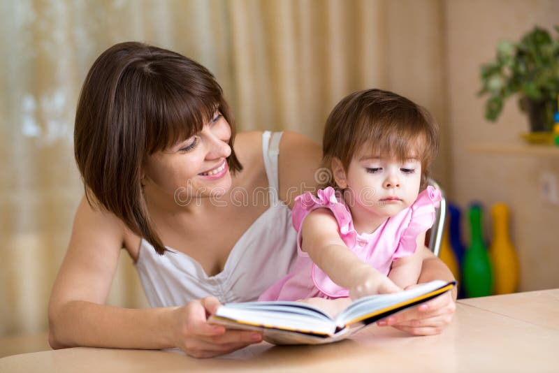 Mother Reading a Book To Kid at Home Stock Image - Image of beautiful ...