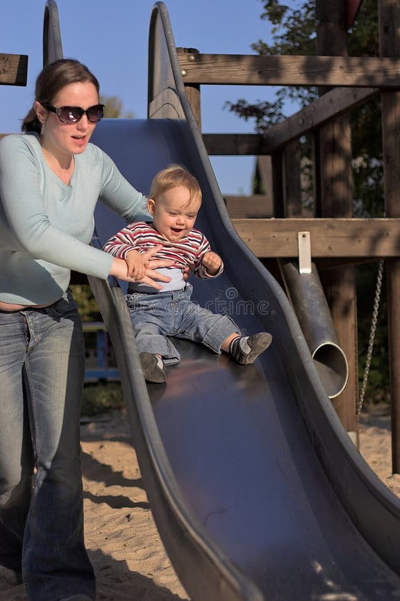 Mother with Child on Slide stock image. Image of blitheness - 3600853