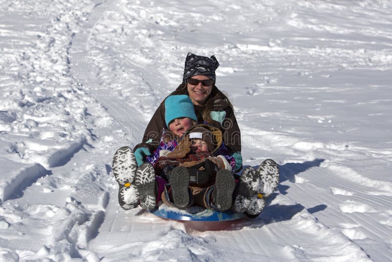 Mother and Children Have Fun Sliding Down the Sled Hill Stock Photo ...