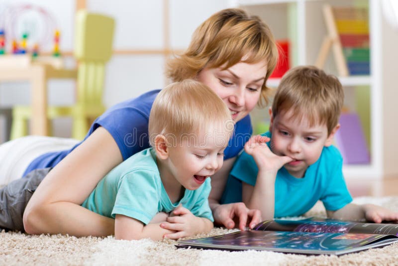 Mother and Children Reading Book at Home Stock Photo - Image of ...