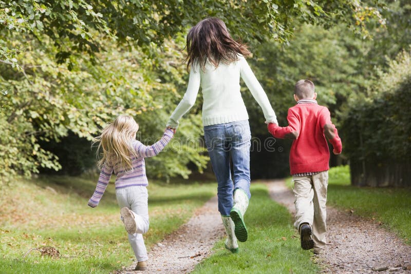 Mother and Children Running Along Woodland Path Stock Image - Image of ...