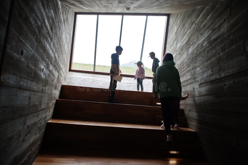 Mother with Children Stand Against Large Panoramic Windows at Cube Room ...