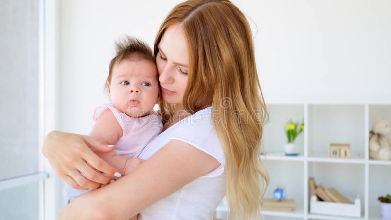 Mother comforting baby stock footage. Video of love - 168734260