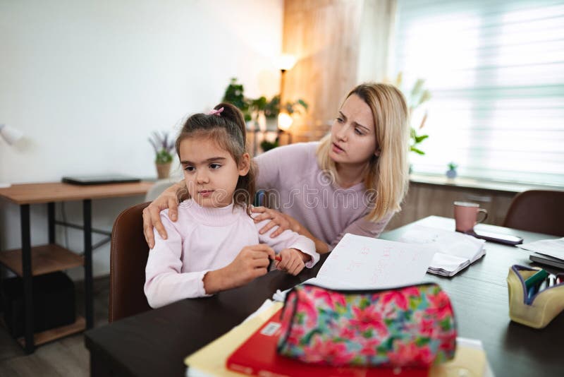 Mother Comforts Daughter during a Challenging Study Session at Home ...