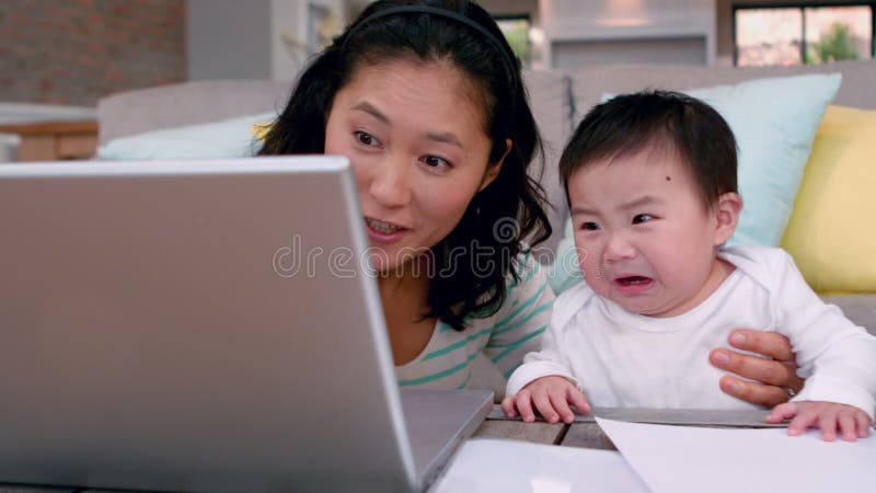 Mother with Crying Baby Using Laptop Stock Footage - Video of adult ...
