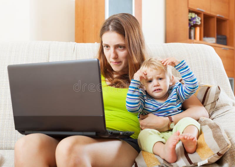 Mother with Crying Baby Working with Laptop Stock Photo - Image of baby ...