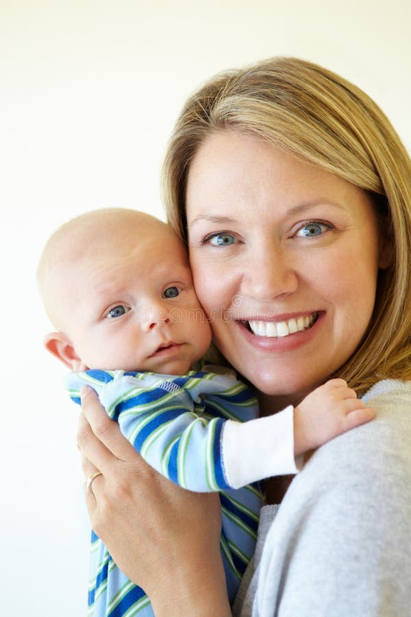 Mother cuddling baby stock photo. Image of indoors, hair - 55892378