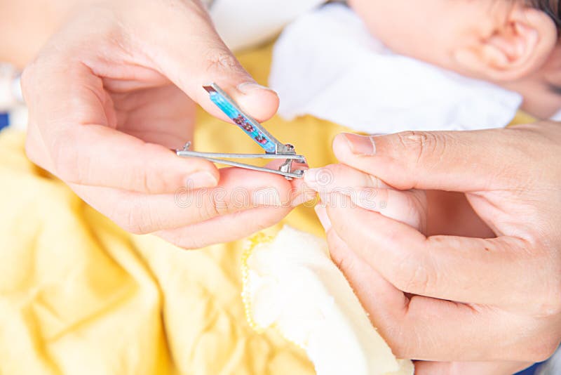 Mother Cutting Babies Nails Stock Image - Image of blue, finger: 151876107