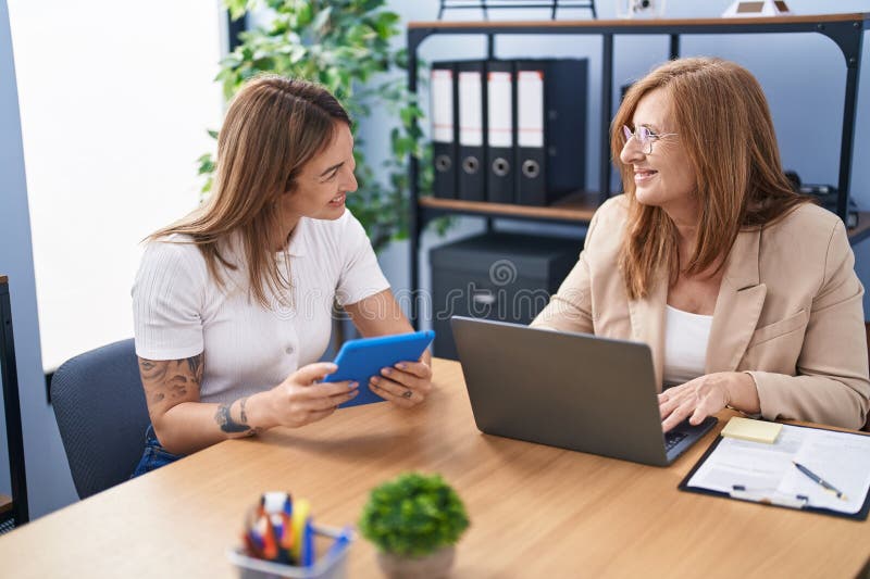 Mother and Daughter Business Workers Using Laptop and Touchpad Working ...
