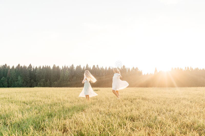 Mother and Daughter Dance in Field, Sunset Light. Stock Image - Image ...