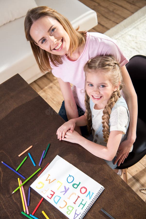 Mother and Daughter Drawing and Learning Alphabet at Home Stock Photo ...