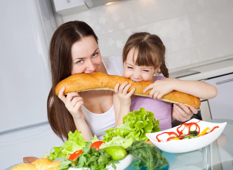 Mother and Daughter Eat Bread Stock Photo - Image of bite, cook: 17115474