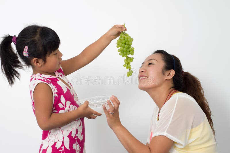 Mother daughter eat fruit stock image. Image of laugh - 26336251