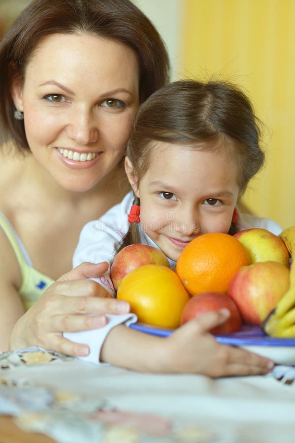Mother and Daughter Eating Fruits Stock Photo - Image of home, small ...