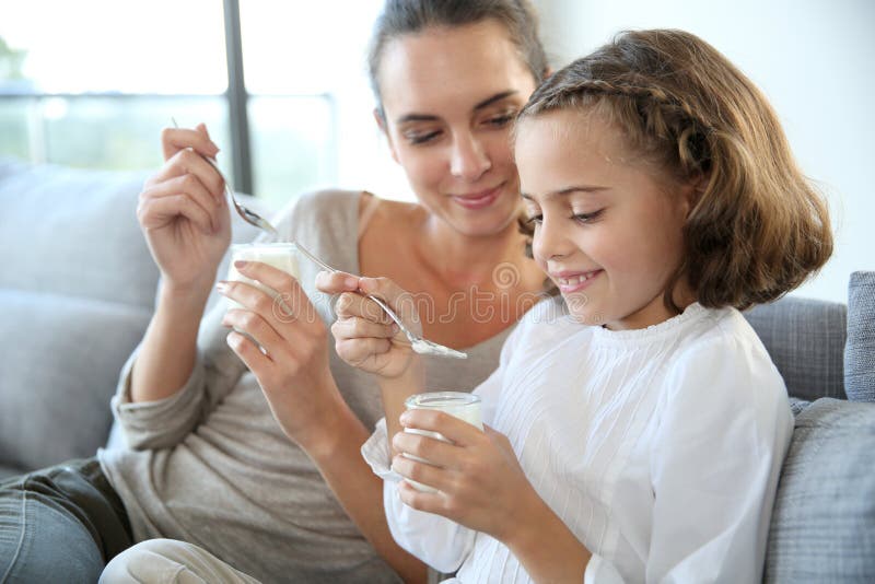 Mother and Daughter Enjoying Eating Yoghurt Stock Photo - Image of ...
