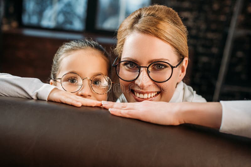 Mother and Daughter in Eyeglasses Looking at Camera while Hiding Stock ...
