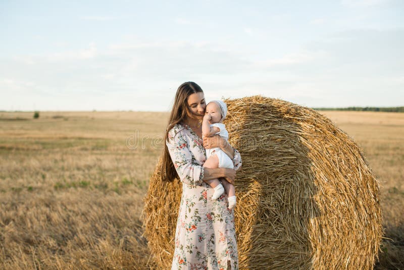 Mother and Daughter in a Field with Stacks Stock Image - Image of ...