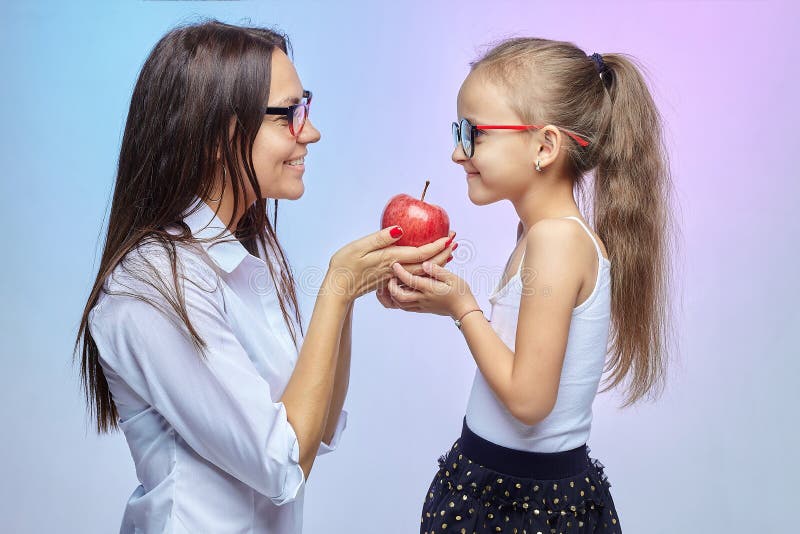 Mother and Daughter Hold a Large Red Apple in Their Hands Stock Photo ...