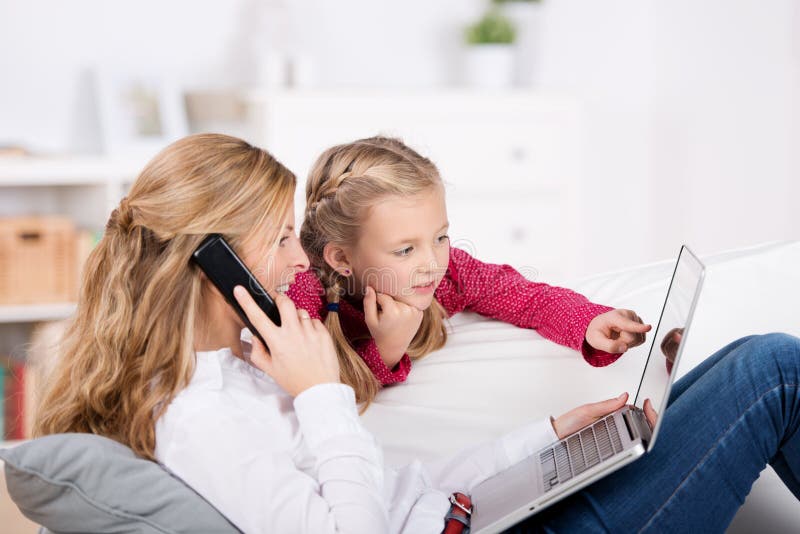 Mother and Daughter with Laptop and Phone Stock Photo - Image of ...