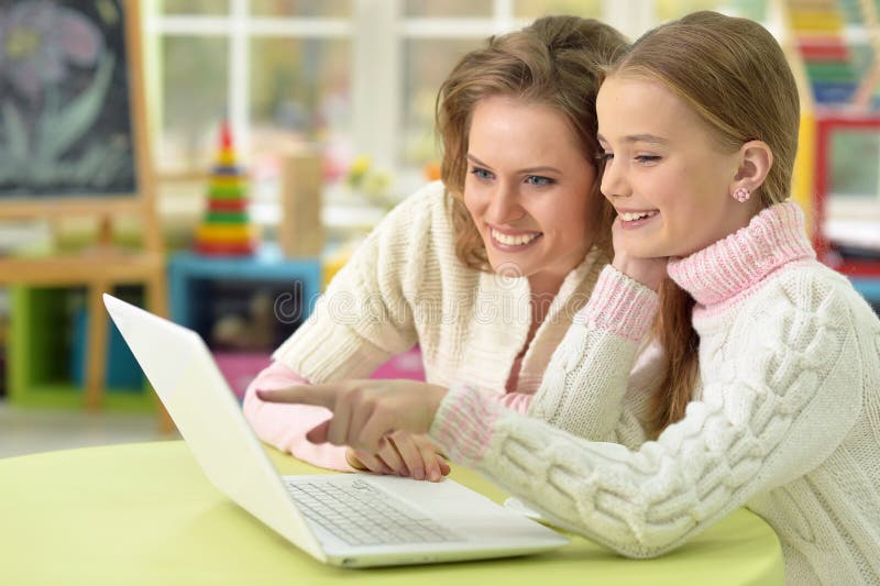 Mother and Daughter with Laptop Stock Image - Image of portrait ...