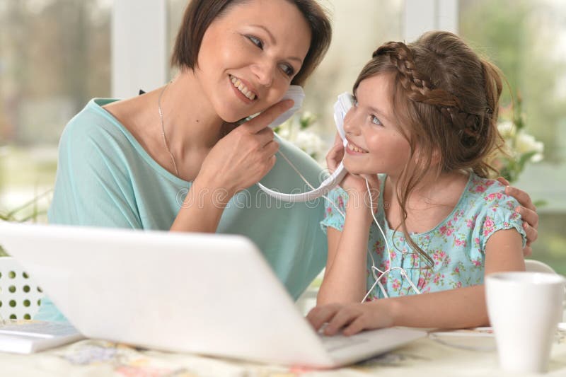 Mother and Daughter Looking at Laptop Computer Stock Photo - Image of ...