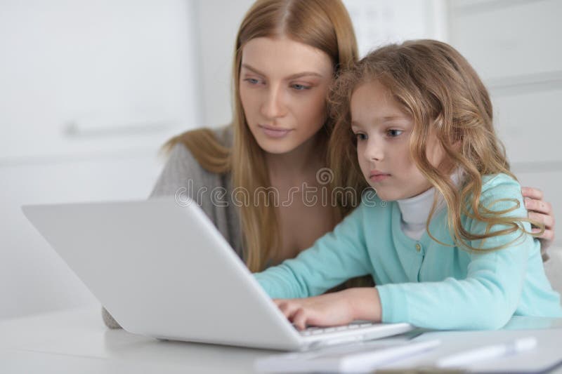 Mother and Daughter Looking at Laptop Computer Stock Photo - Image of ...