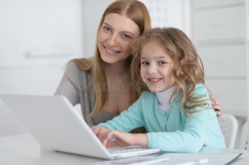 Mother and Daughter Looking at Laptop Computer Stock Image - Image of ...